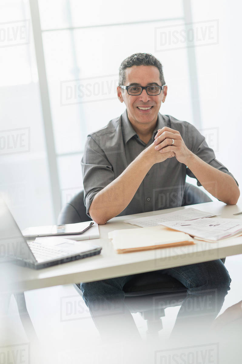 Portrait of man at desk in office - Royalty-free Stock Photo | Dissolve
