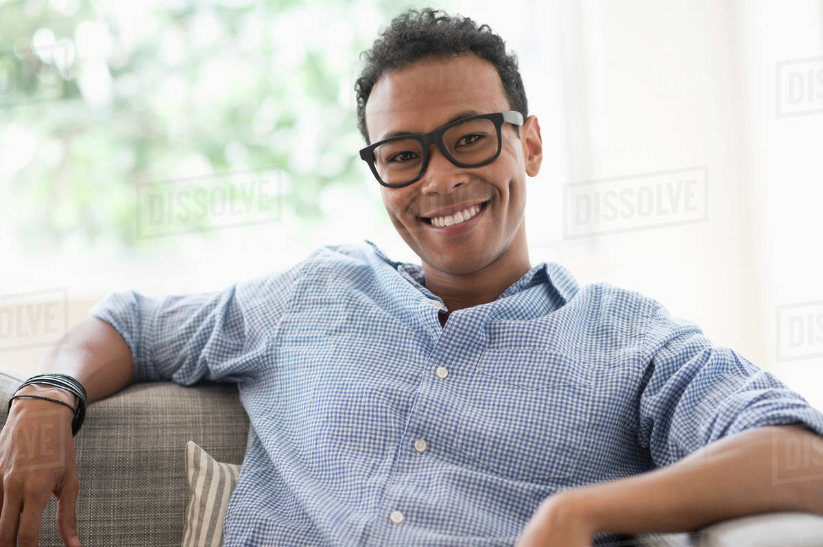 Portrait of young relaxed man smiling - Stock Photo - Dissolve