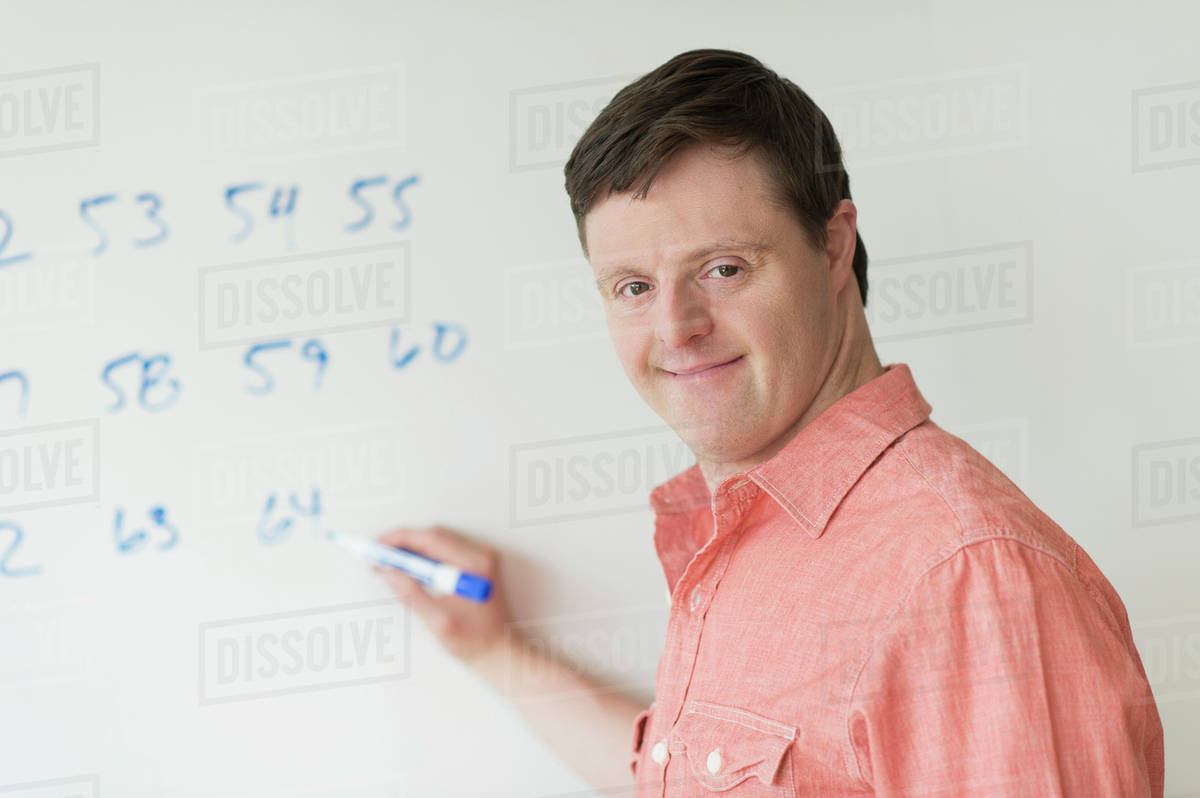 Man with down syndrome writing on whiteboard - Royalty-free Stock Photo ...