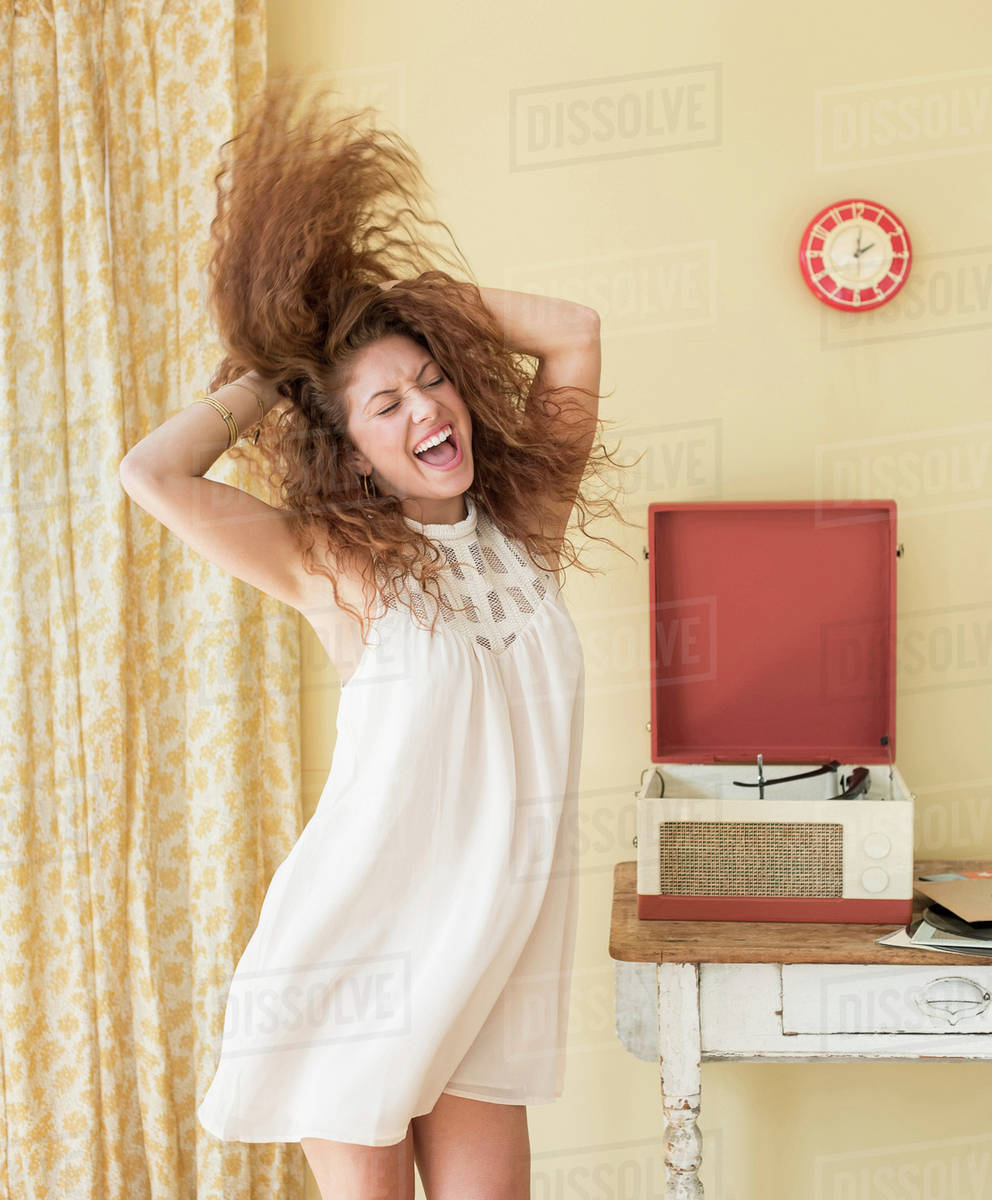 Portrait of woman dancing happily in room - Royalty-free Stock Photo ...