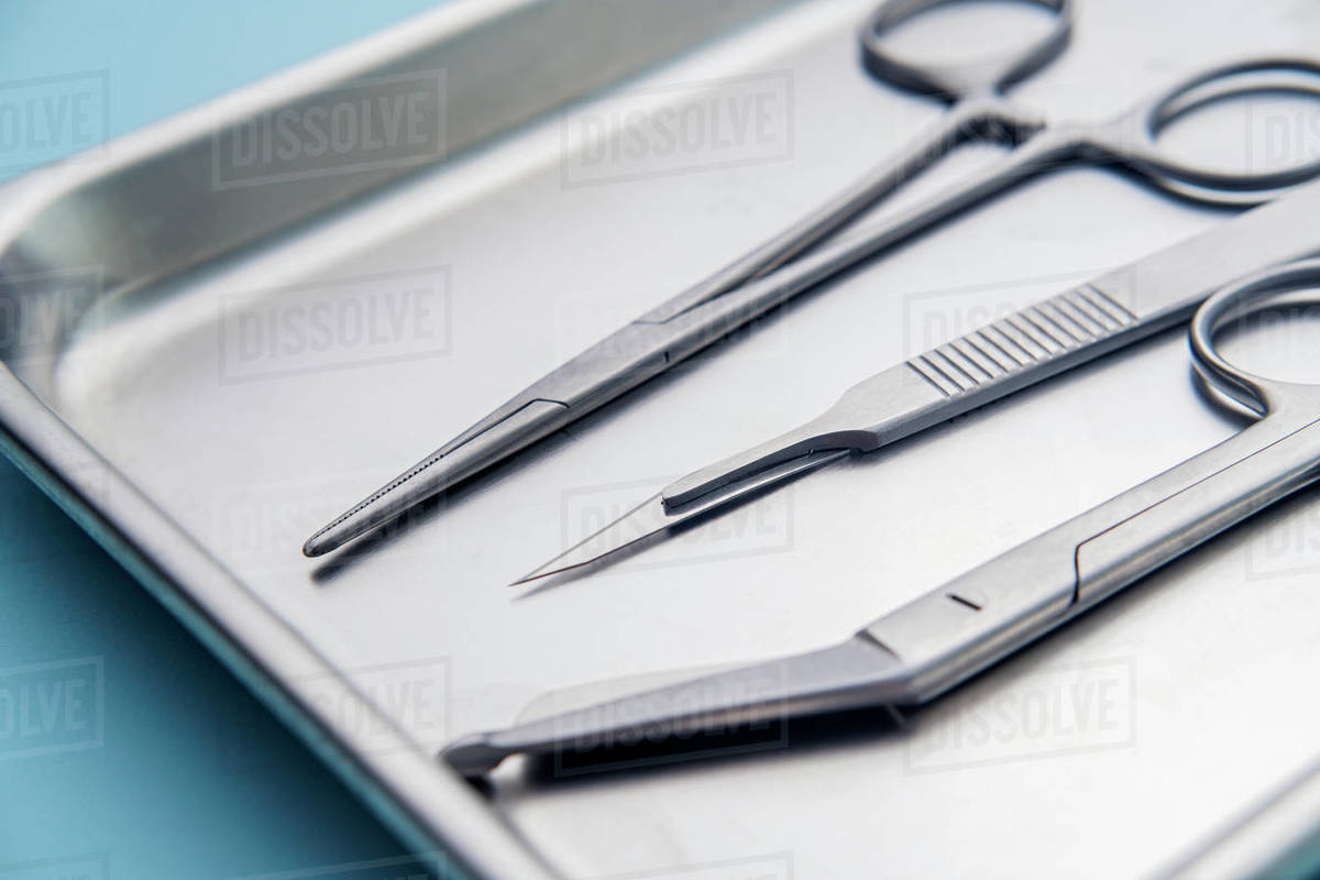 Forceps and scalpel on tray - Royalty-free Stock Photo | Dissolve
