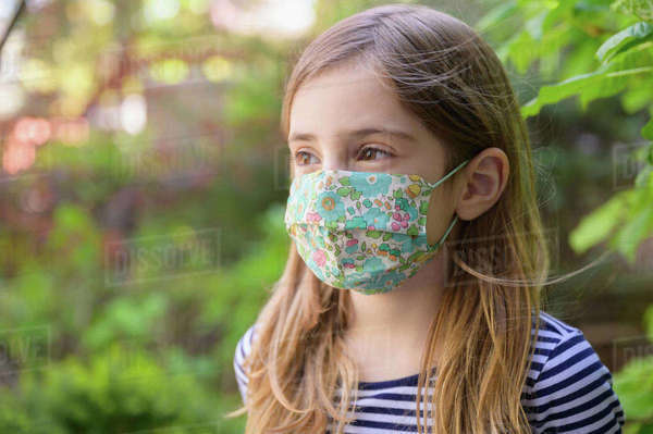 Girl (-6-7) wearing face mask - Stock Photo - Dissolve