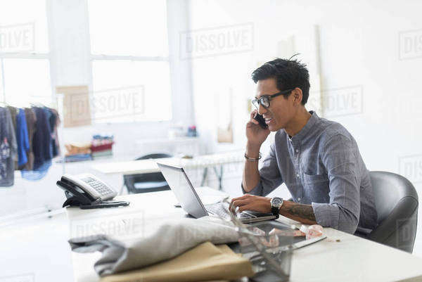 Side view of man working in studio - Royalty-free Stock Photo | Dissolve