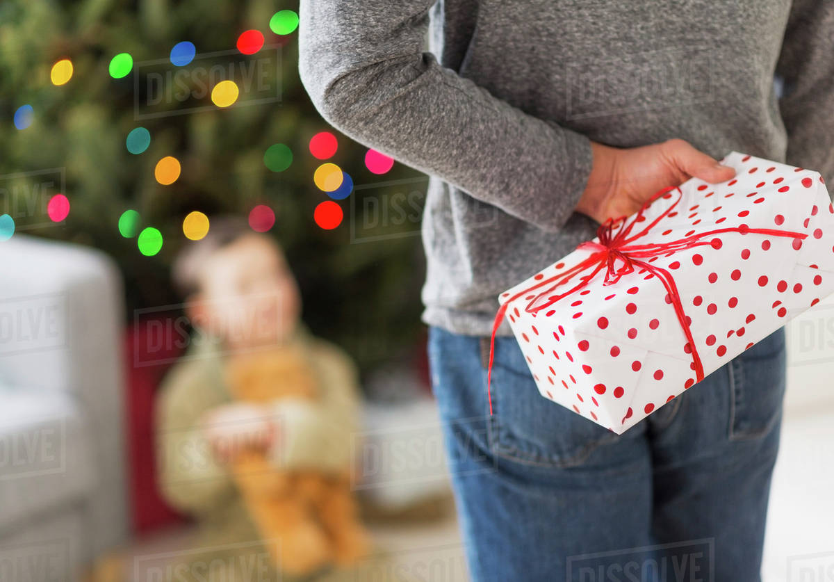 Man holding present - Stock Photo - Dissolve