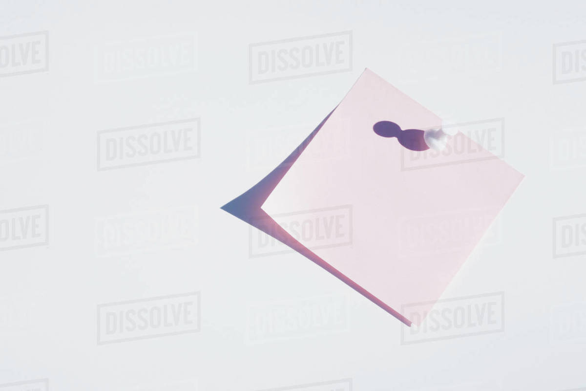 Studio shot of blank pink adhesive post it note - Stock Photo - Dissolve