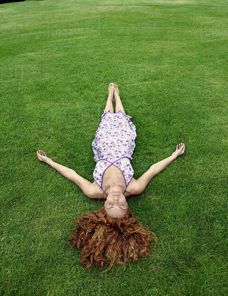 Young woman lying in lawn - Royalty-free Stock Photo | Dissolve
