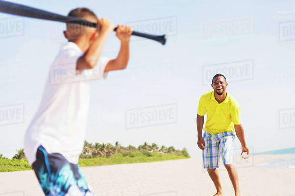 Father and son (10-11) playing baseball on beach - Royalty-free Stock ...