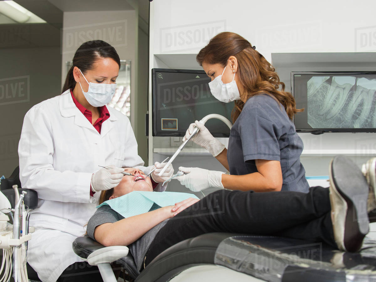 Dentist operation on patient - Royalty-free Stock Photo | Dissolve