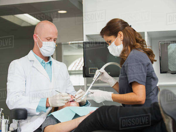 Dentist operation on patient - Royalty-free Stock Photo | Dissolve