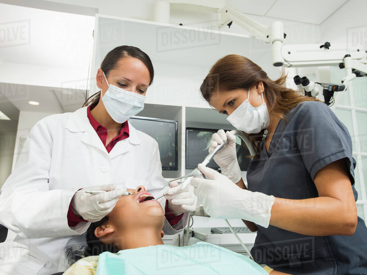 Dentist operation on patient(10-11) - Royalty-free Stock Photo | Dissolve
