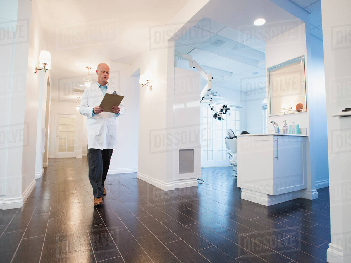 Doctor walking through corridor of clinic - Royalty-free Stock Photo ...