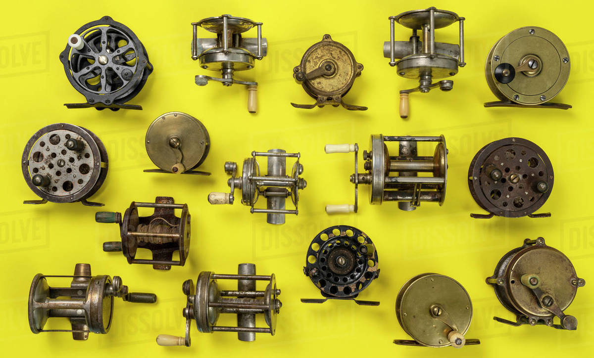 Vintage fishing reels on yellow background - Royalty-free Stock Photo ...