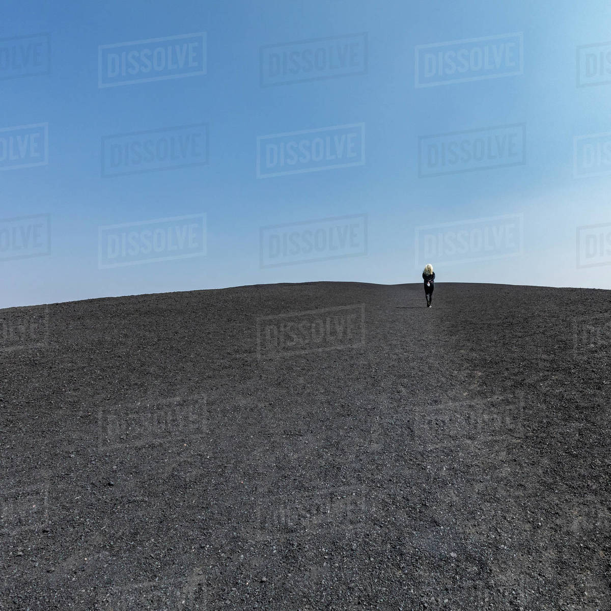 Woman hiking in cinder cone at Craters of the Moon National Monument ...