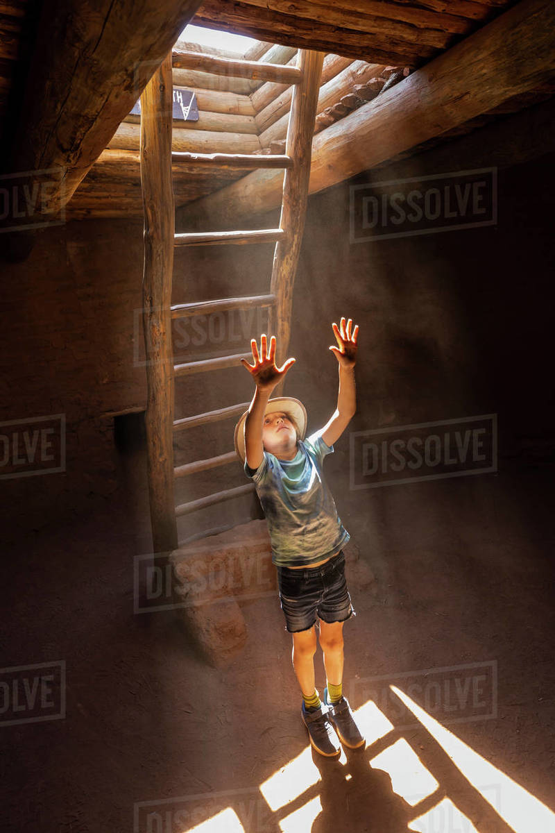 Boy (8-9) exploring Native American kiva in Pecos National Monument ...