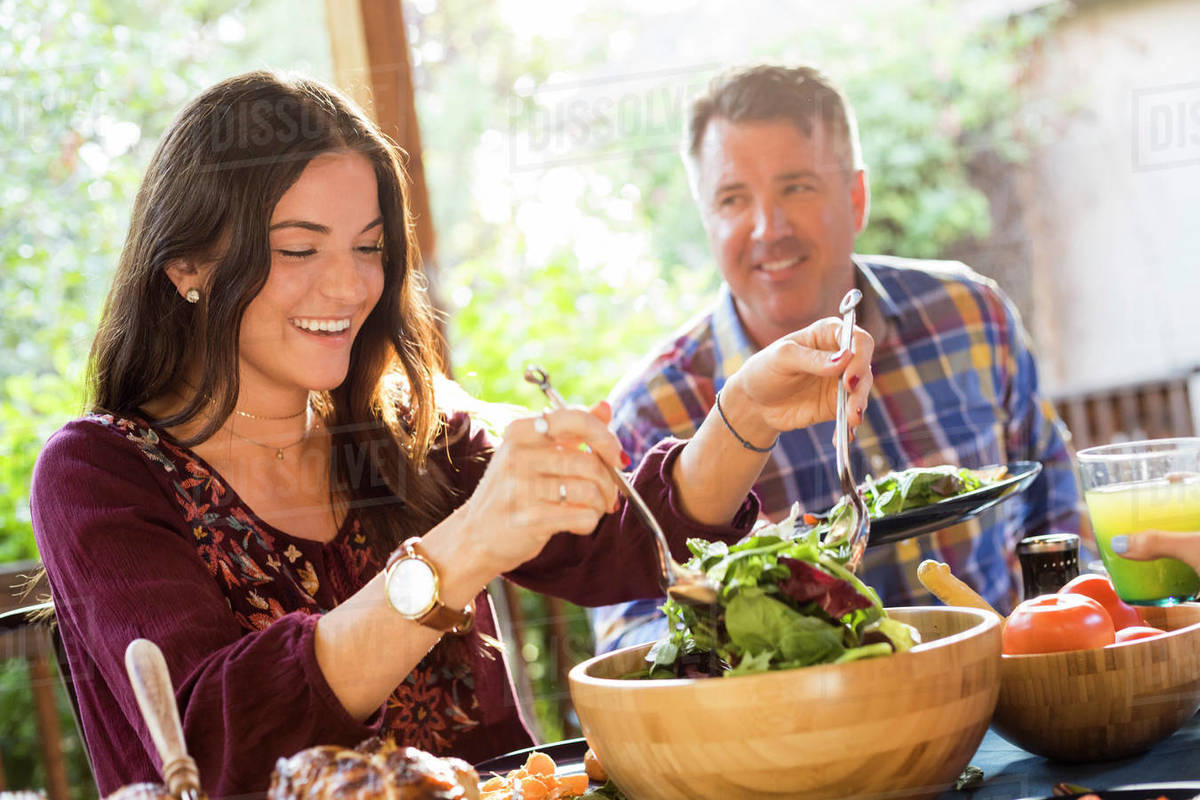 Father and daughter (10-11) eating dinner - Royalty-free Stock Photo ...