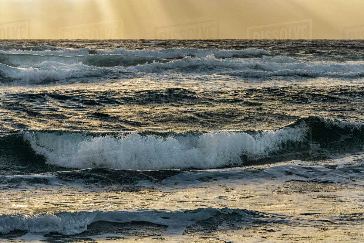 Ocean waves splashing in morning light - Stock Photo - Dissolve