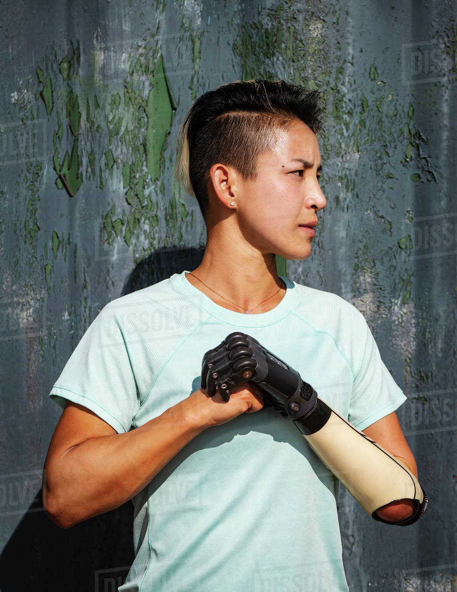 Portrait of athlete woman with prosthetic arm - Stock Photo - Dissolve