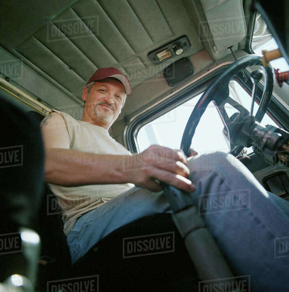 Portrait of happy truck driver - Stock Photo - Dissolve