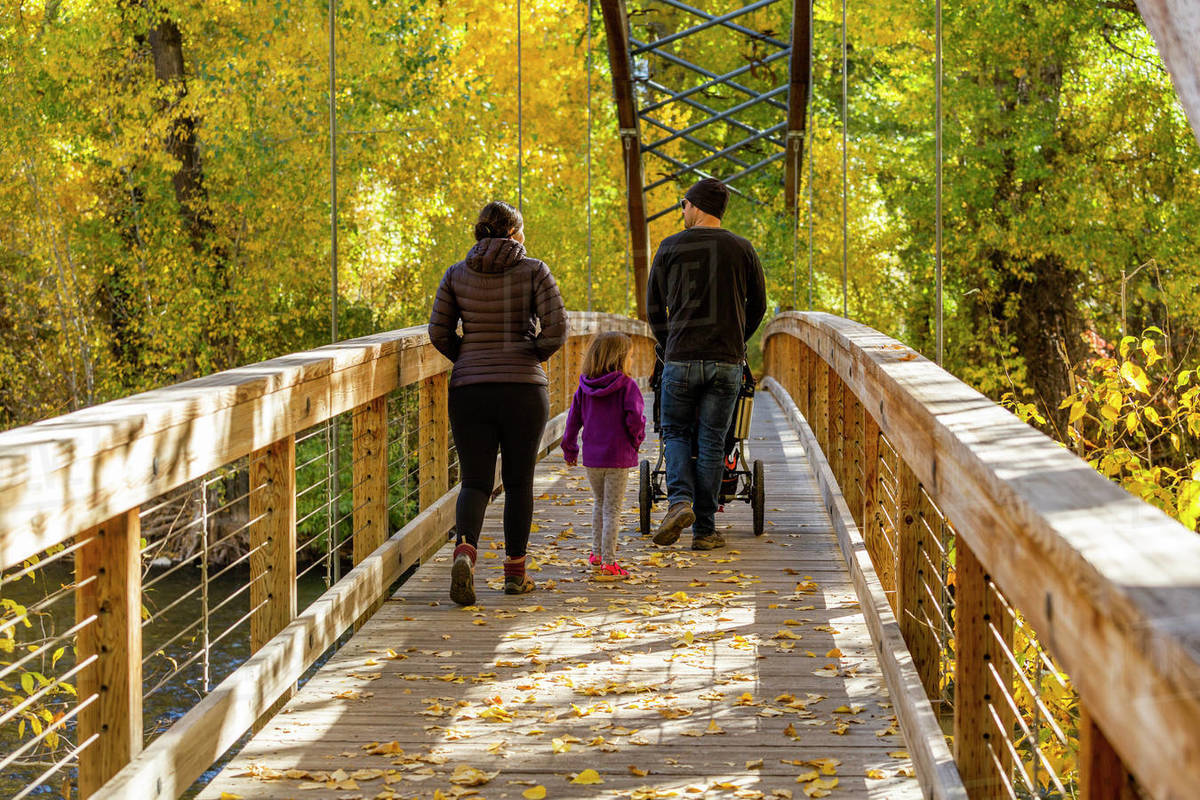 USA, Idaho, Hailey, Family crossing bridge in autumn - Royalty-free ...