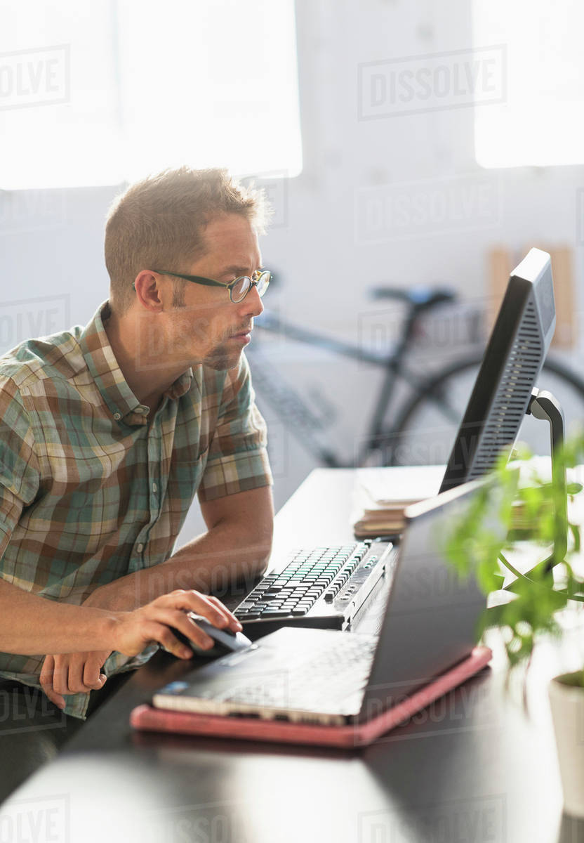 Man using computer in office - Royalty-free Stock Photo | Dissolve