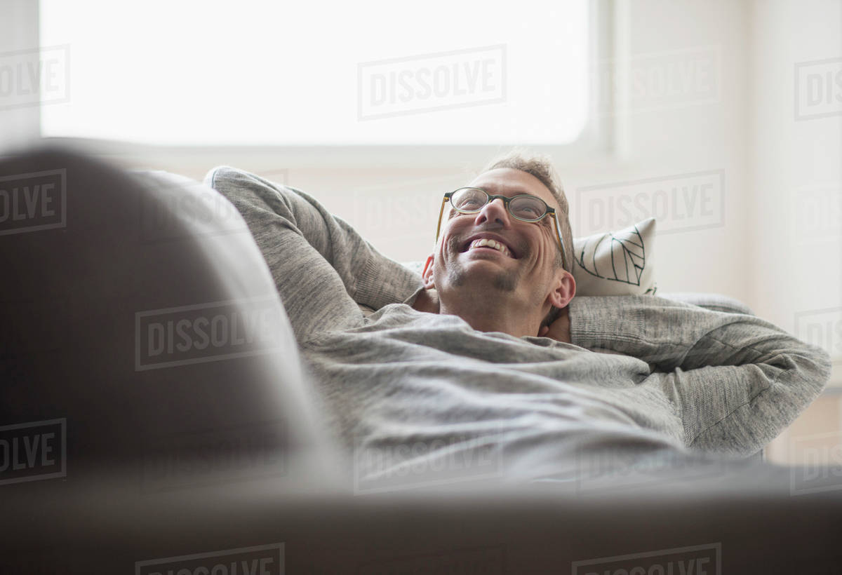 Man lying on sofa - Royalty-free Stock Photo | Dissolve