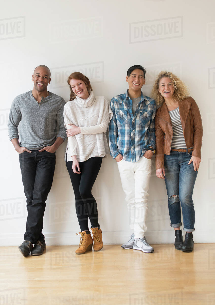 Group of friends standing in front of white wall - Royalty-free Stock ...