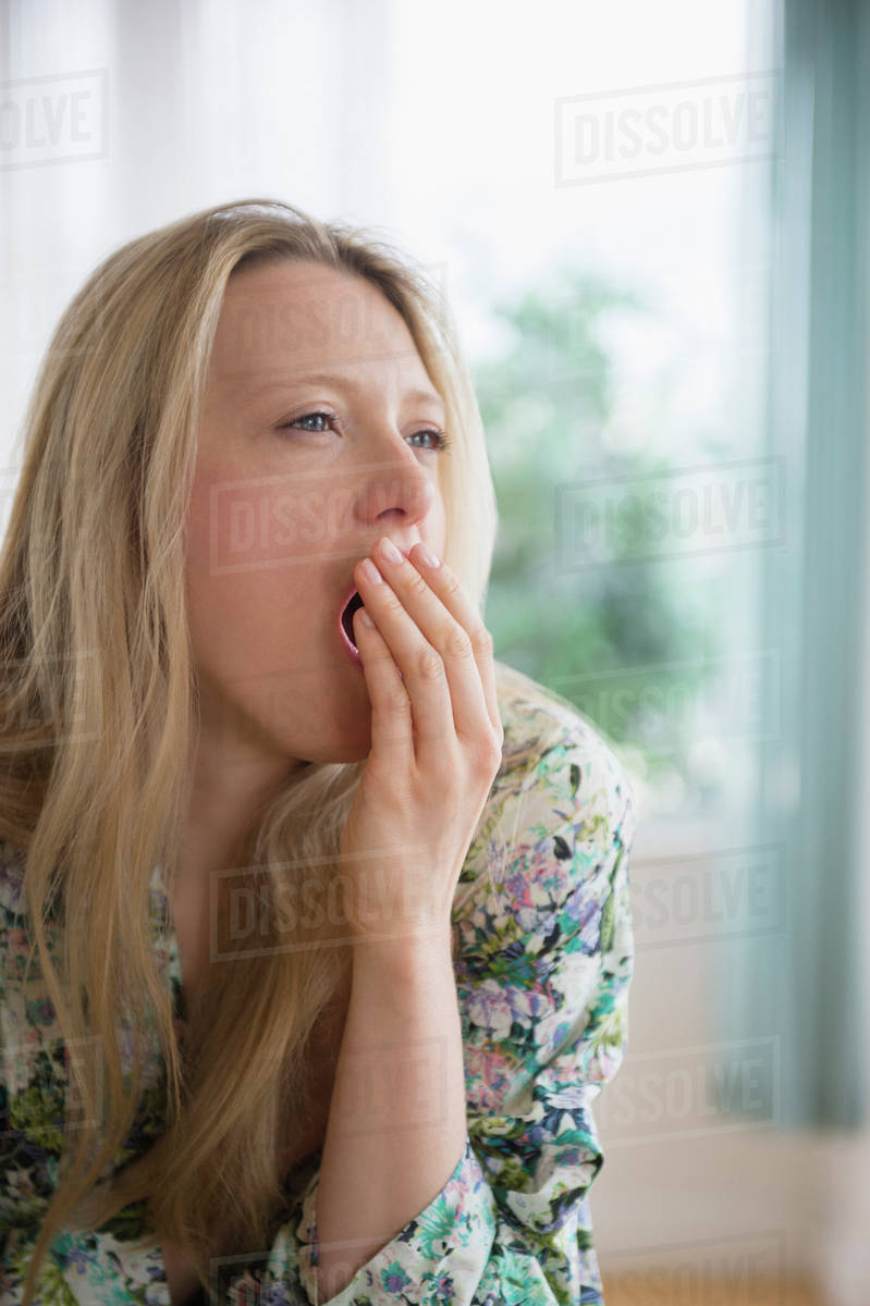 Portrait of woman yawning - Royalty-free Stock Photo | Dissolve