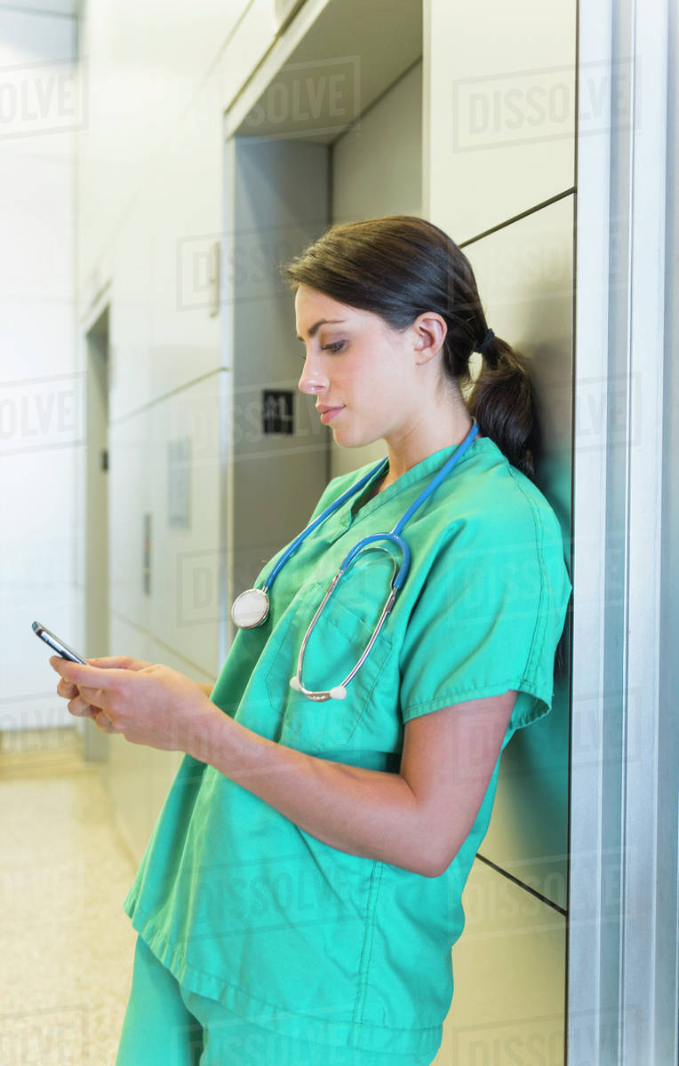 Female doctor text messaging - Royalty-free Stock Photo | Dissolve