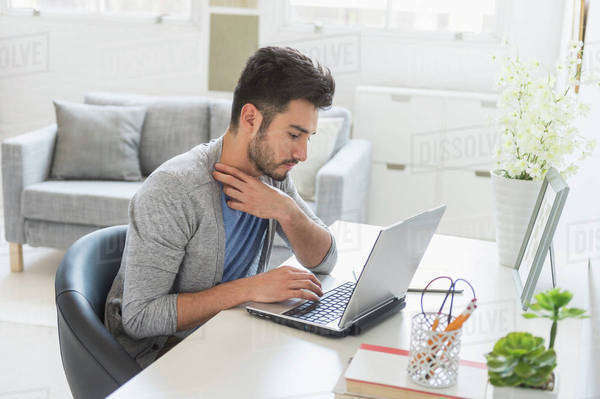 Man using laptop at home - Royalty-free Stock Photo | Dissolve