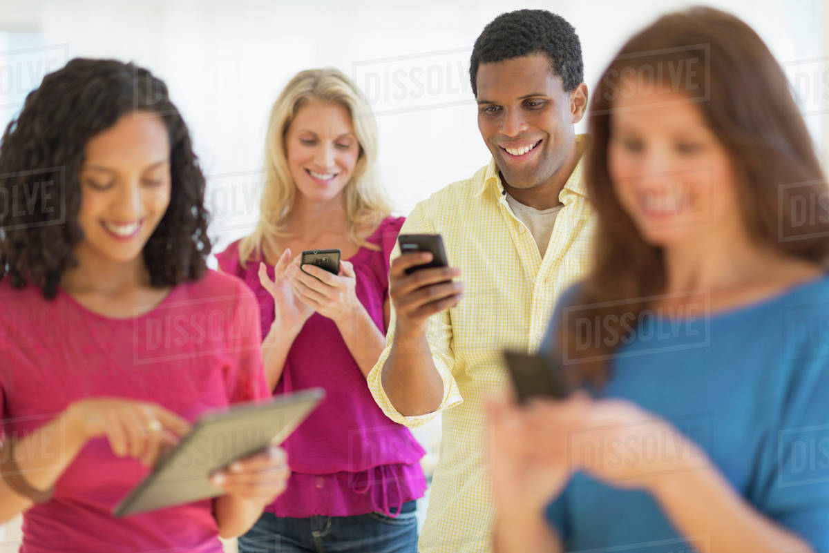 People using communication devices - Stock Photo - Dissolve