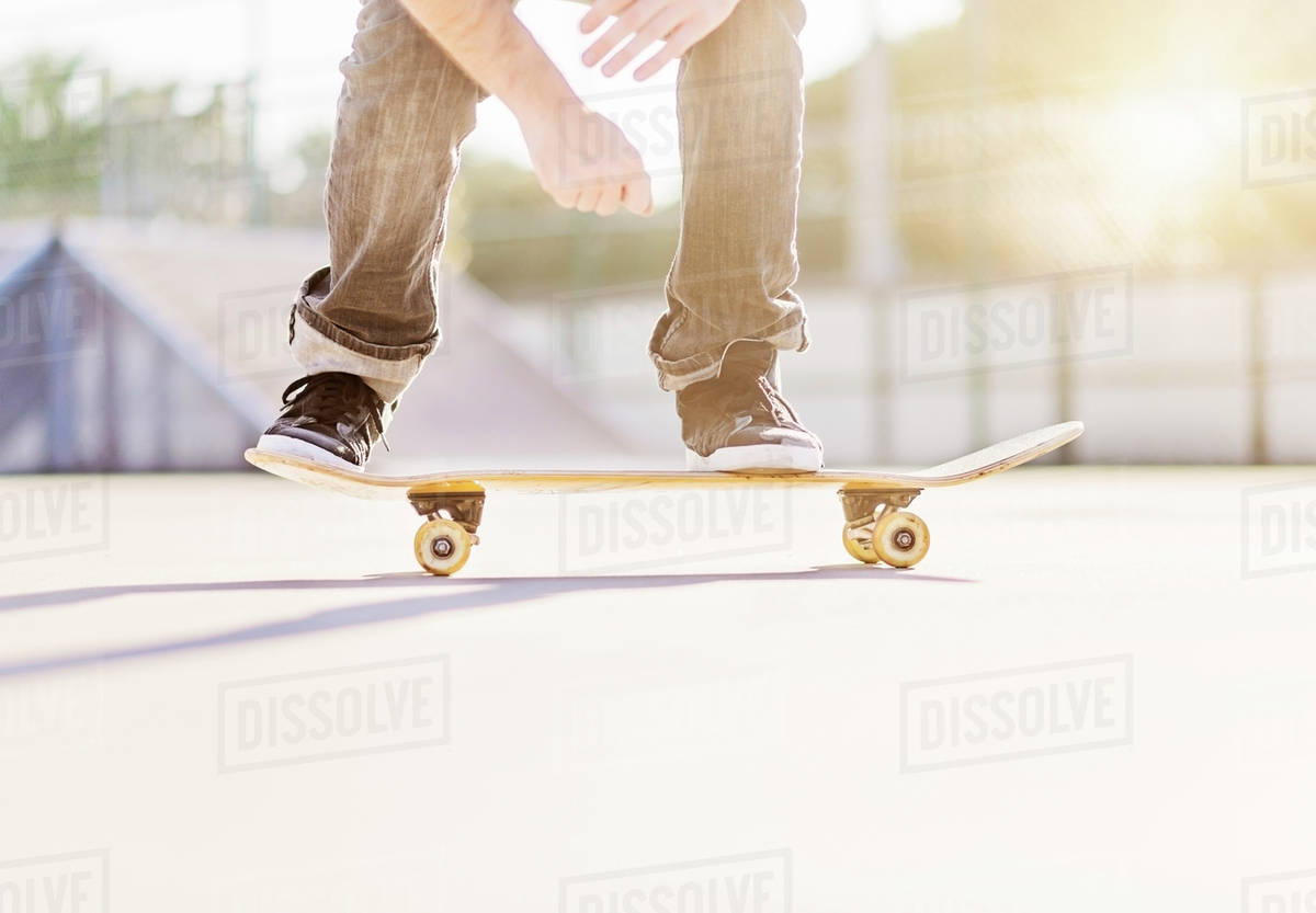 Man skateboarding in skatepark - Stock Photo - Dissolve