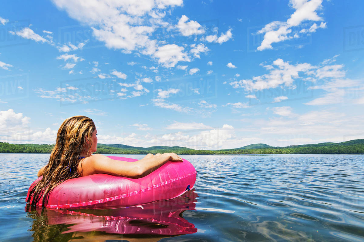 Young woman relaxing on lake in pool raft - Royalty-free Stock Photo ...