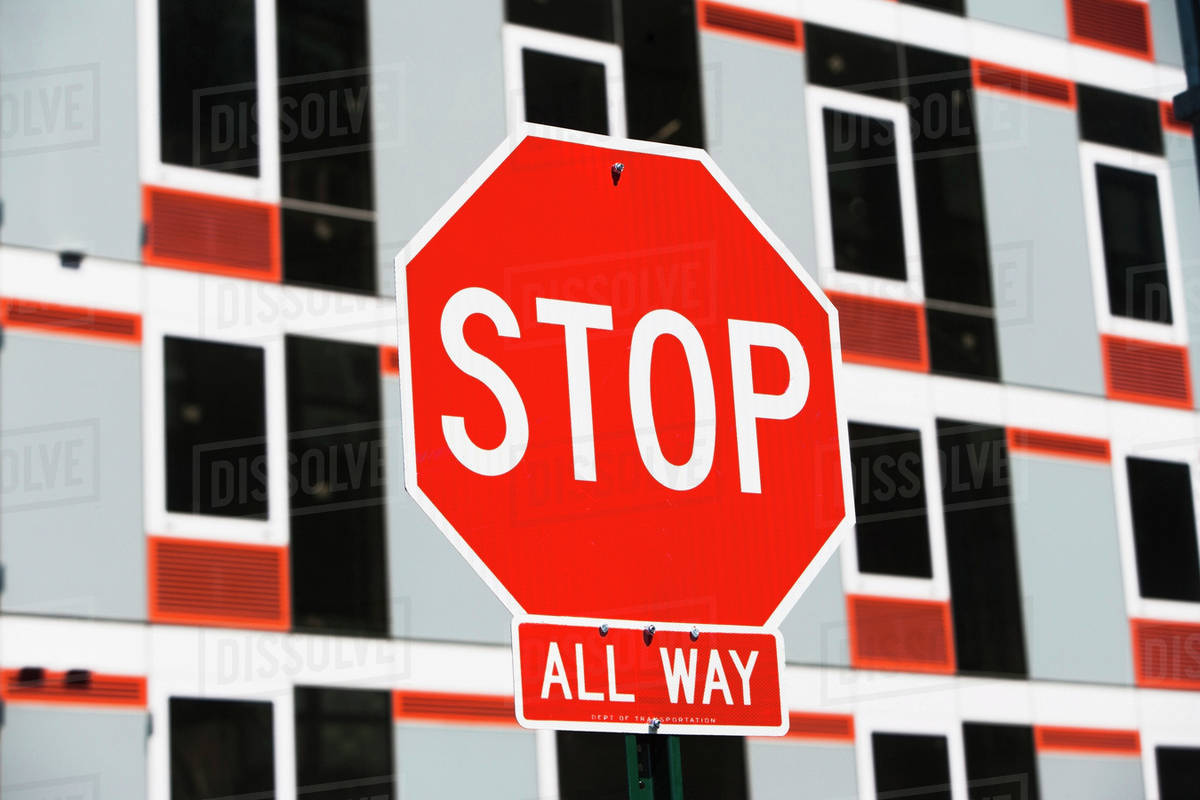 Stop sign with building in background - Royalty-free Stock Photo | Dissolve