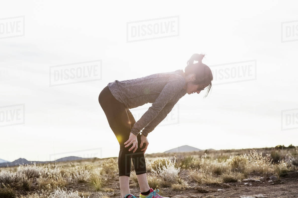 Female runner taking a break - Stock Photo - Dissolve