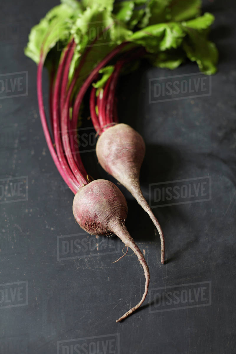 Two beets on black background - Stock Photo - Dissolve