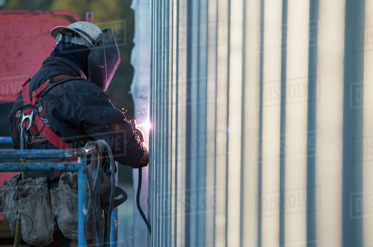 Man welding steel bar - Stock Photo - Dissolve