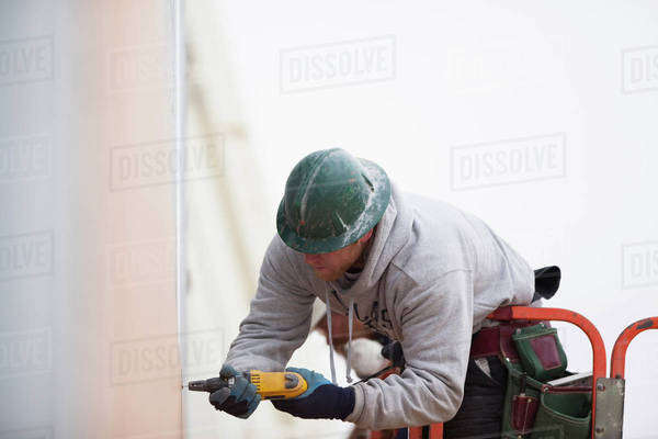 Man working at construction site - Royalty-free Stock Photo | Dissolve