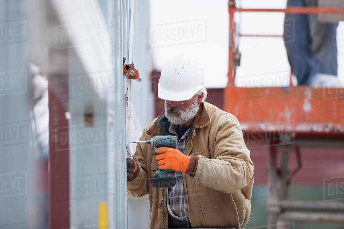 Man working at construction site - Royalty-free Stock Photo | Dissolve