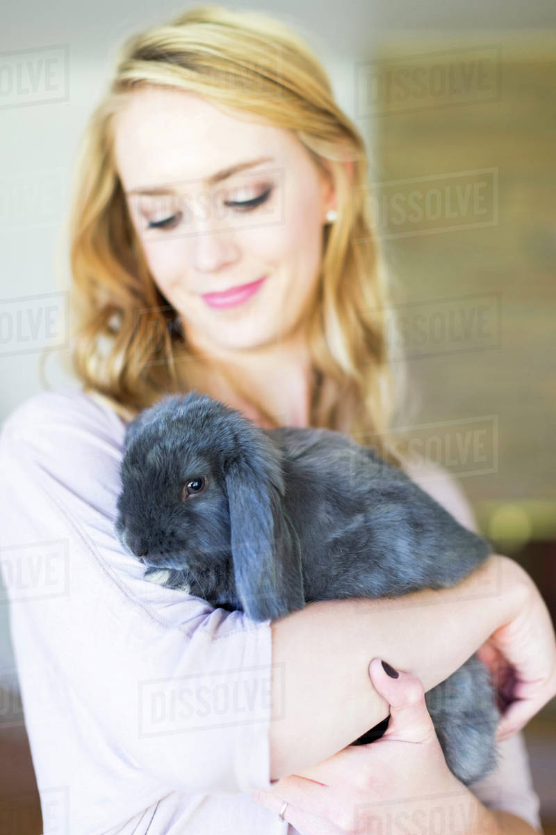 Young woman holding bunny - Royalty-free Stock Photo | Dissolve