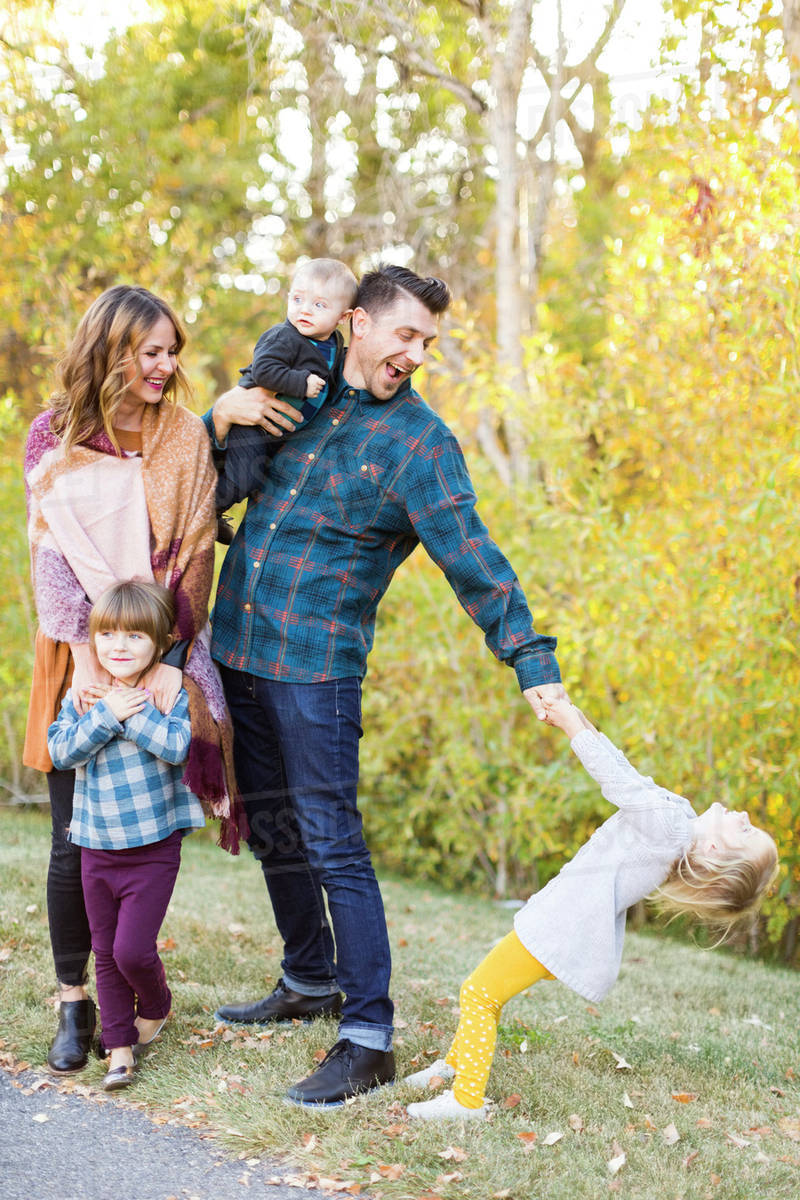 Happy family with tree children (6-11 months, 2-3, 4-5) in park - Stock ...