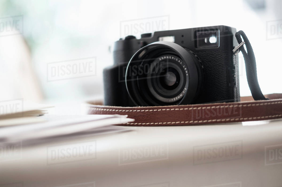 Digital camera on desk - Stock Photo - Dissolve