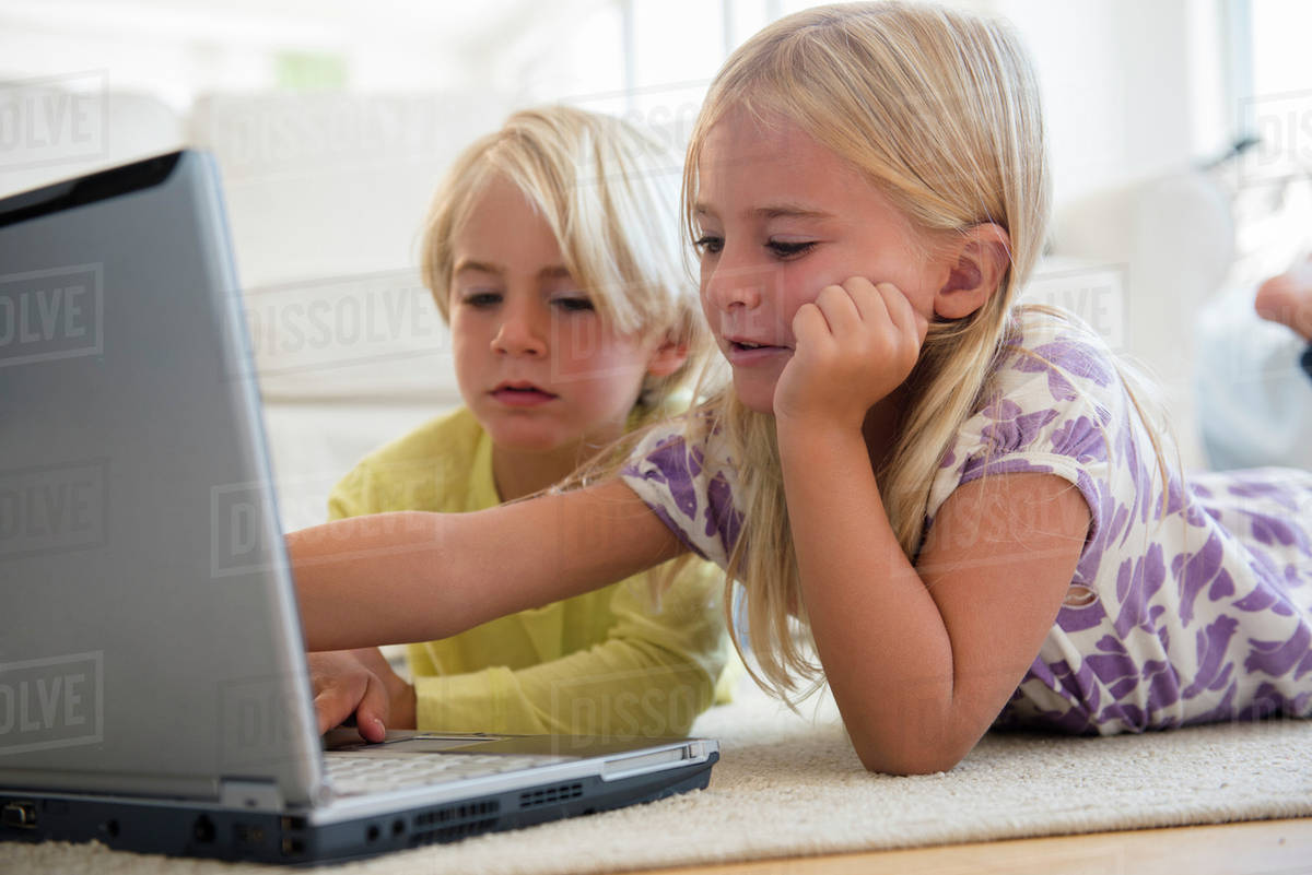 Boy (4-5) and girl (6-7) using laptop - Royalty-free Stock Photo | Dissolve