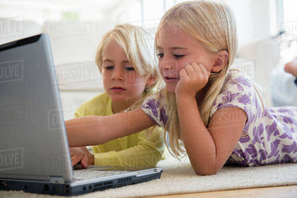 Boy (4-5) and girl (6-7) using laptop - Royalty-free Stock Photo | Dissolve