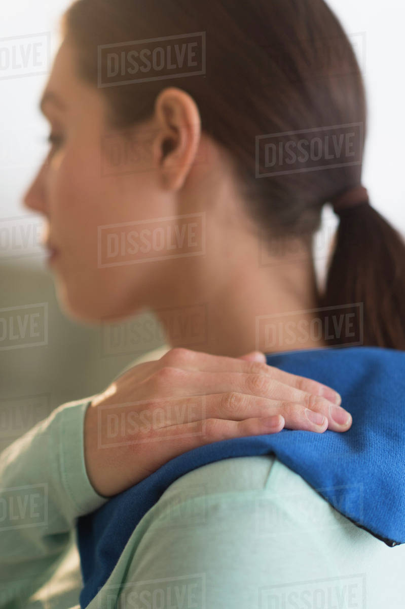 Woman touching aching back - Royalty-free Stock Photo | Dissolve