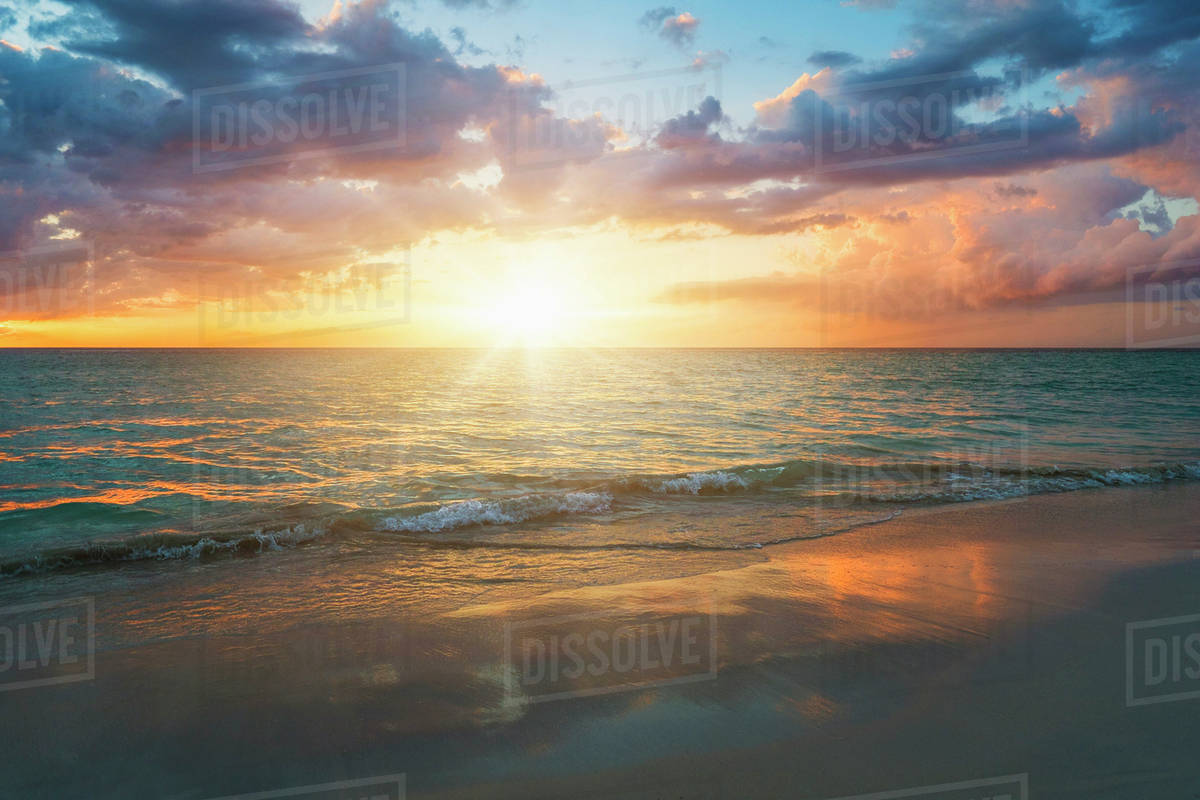 Sun setting over sea - Royalty-free Stock Photo | Dissolve
