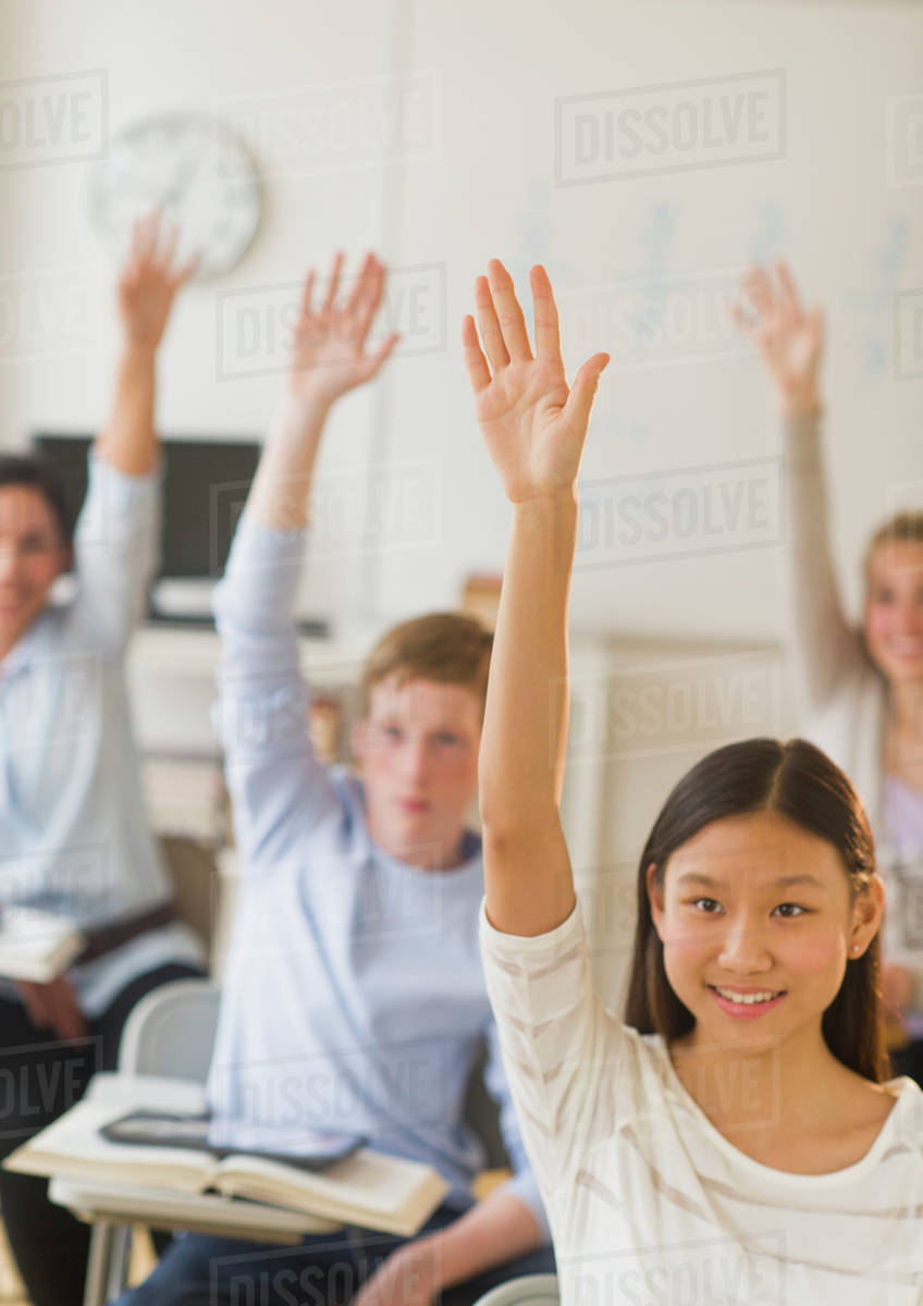 Students (14-19) raising hands - Stock Photo - Dissolve