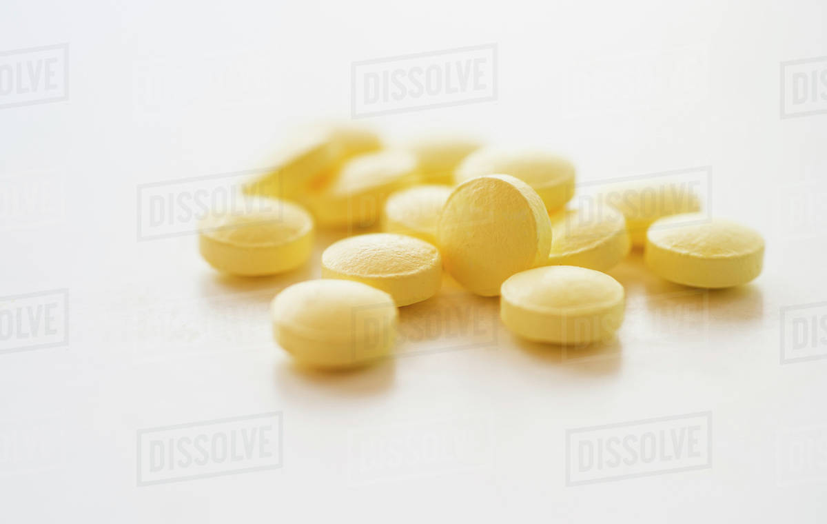 Yellow pills, studio shot - Royalty-free Stock Photo | Dissolve