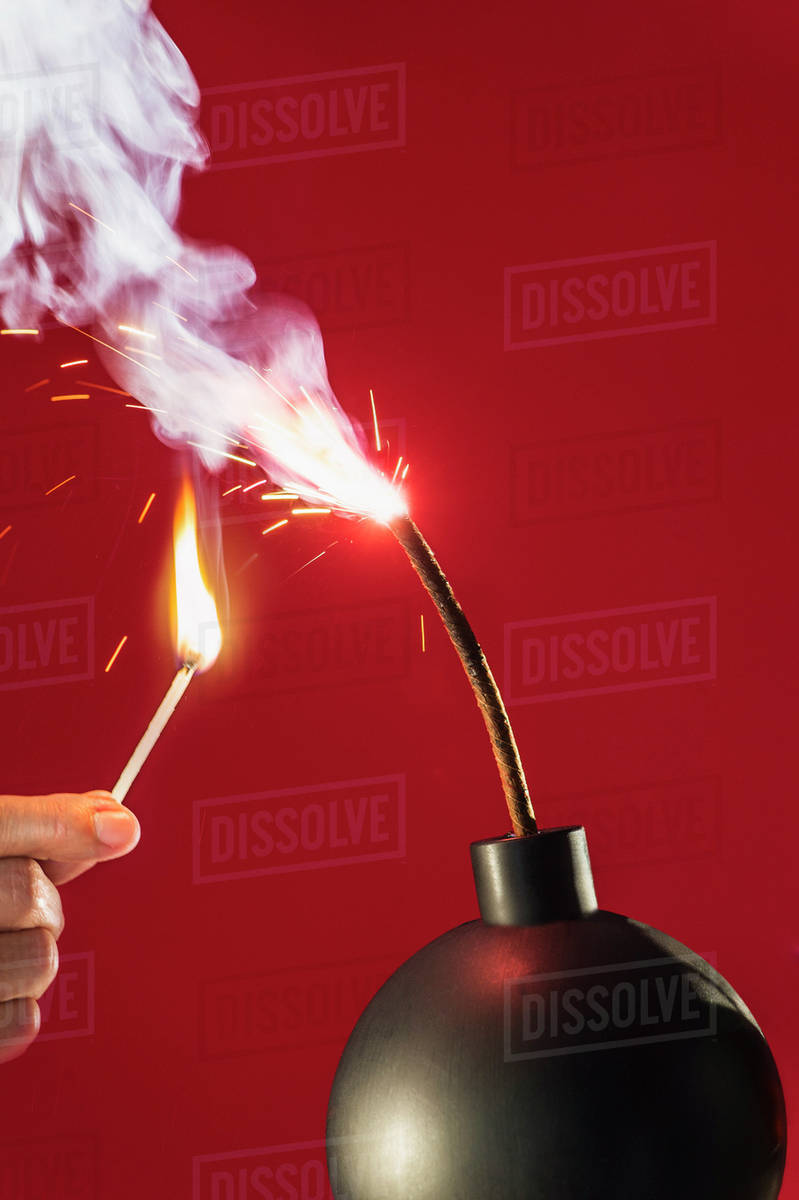 Old-fashioned explosive device ready to go off with hand holding ...