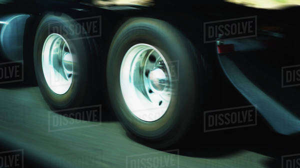 Wheels of truck in motion - Stock Photo - Dissolve