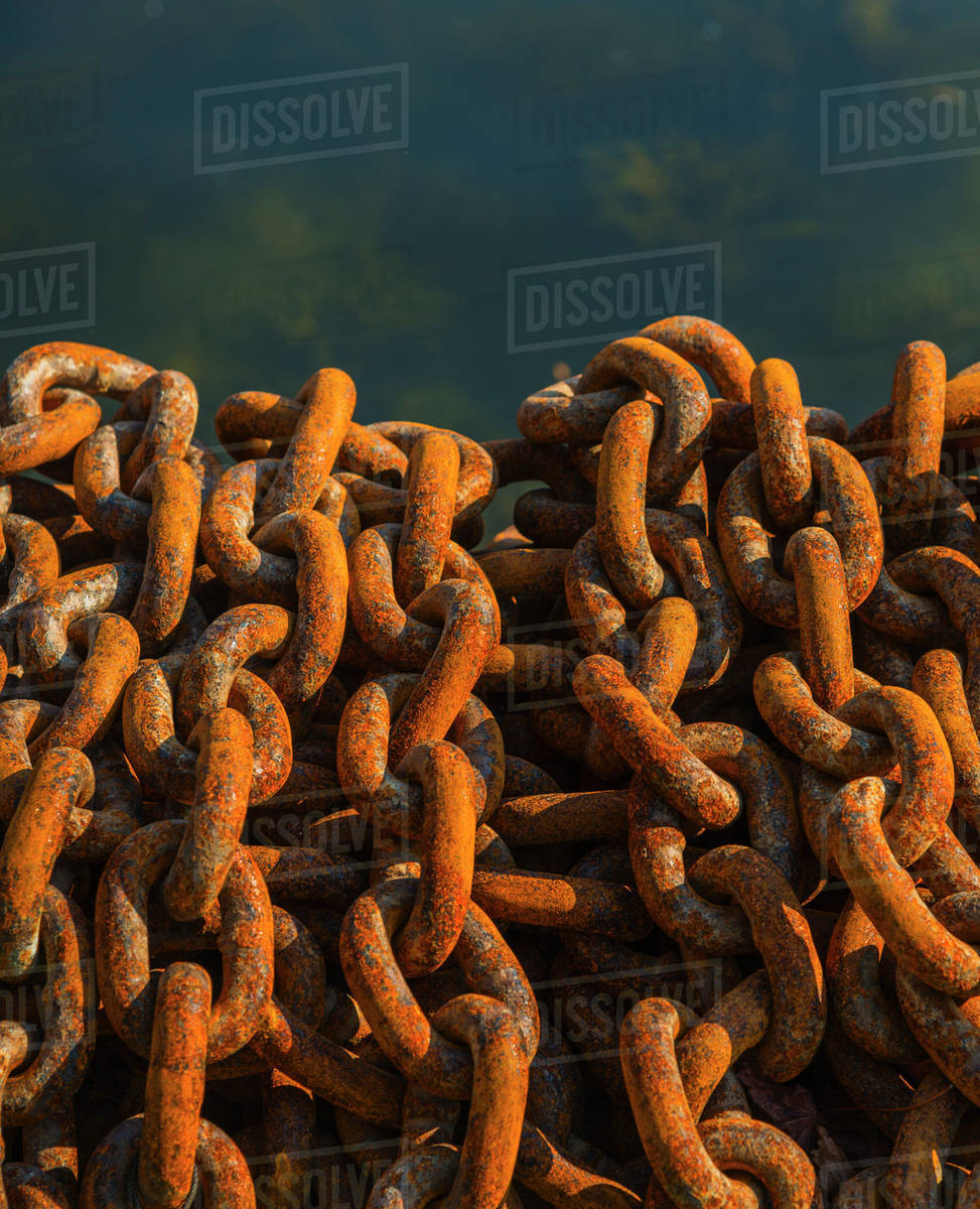 Rusty chains in harbor - Stock Photo - Dissolve